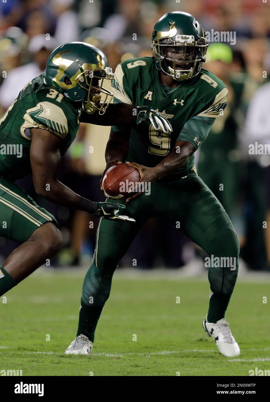 South Florida quarterback Quinton Flowers (9) hands off to running back ...