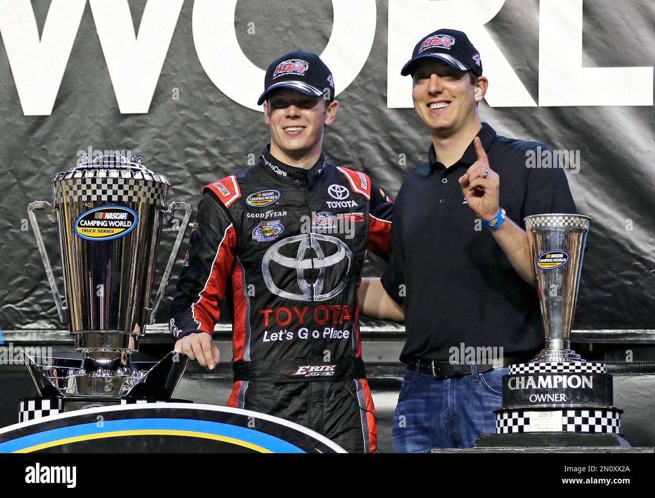 Erik Jones, left, and team owner Kyle Busch pose with the trophies ...
