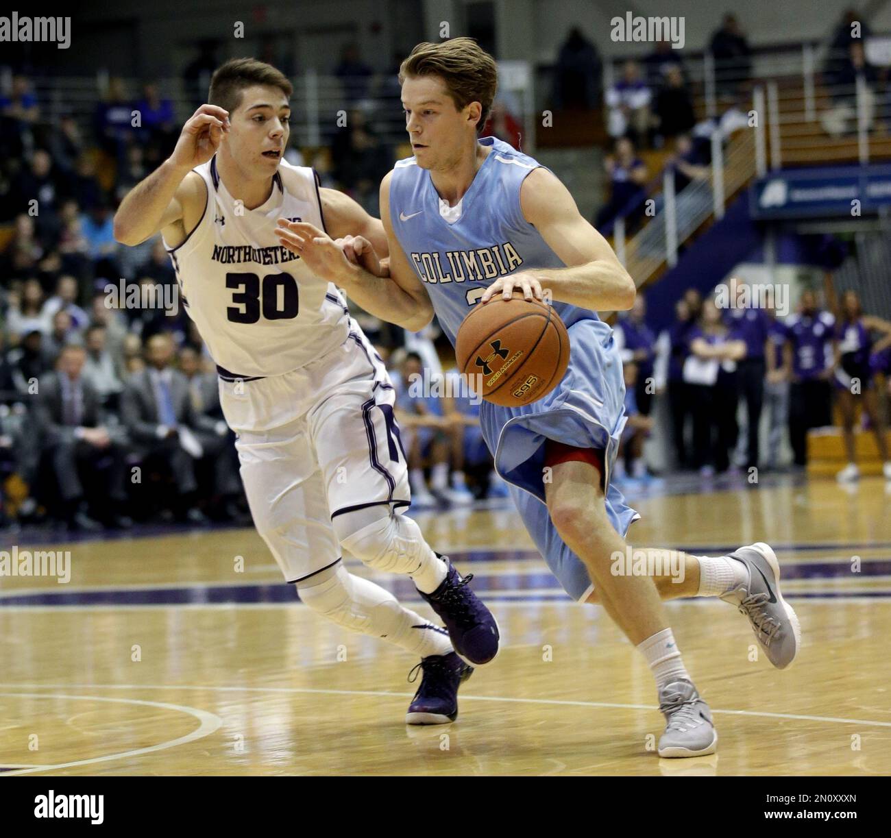 Columbia guard Grant Mullins, right, drives as Northwestern guard ...
