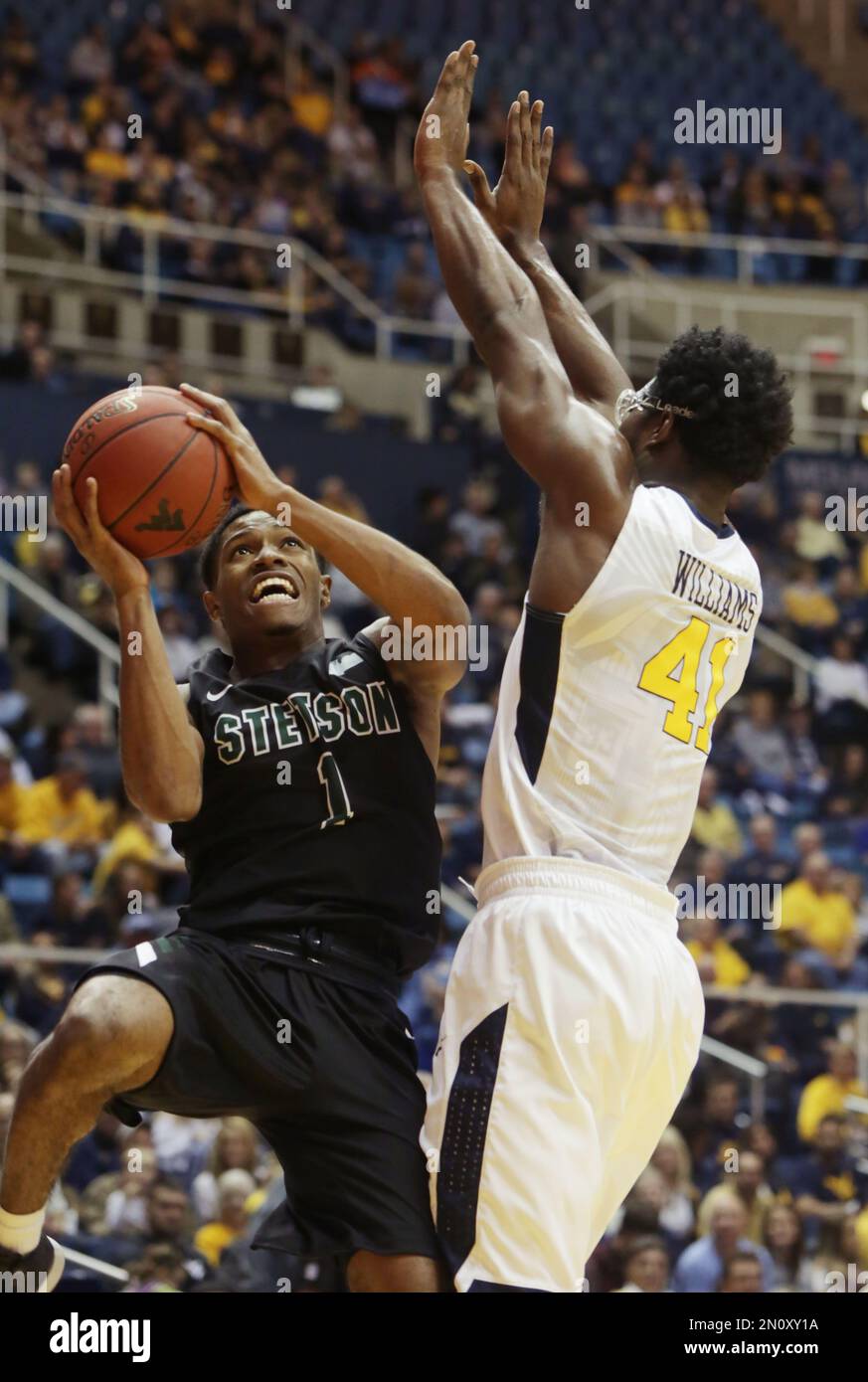 Stetson guard Ty Cockfield (1) tries to shoot around West Virginia ...