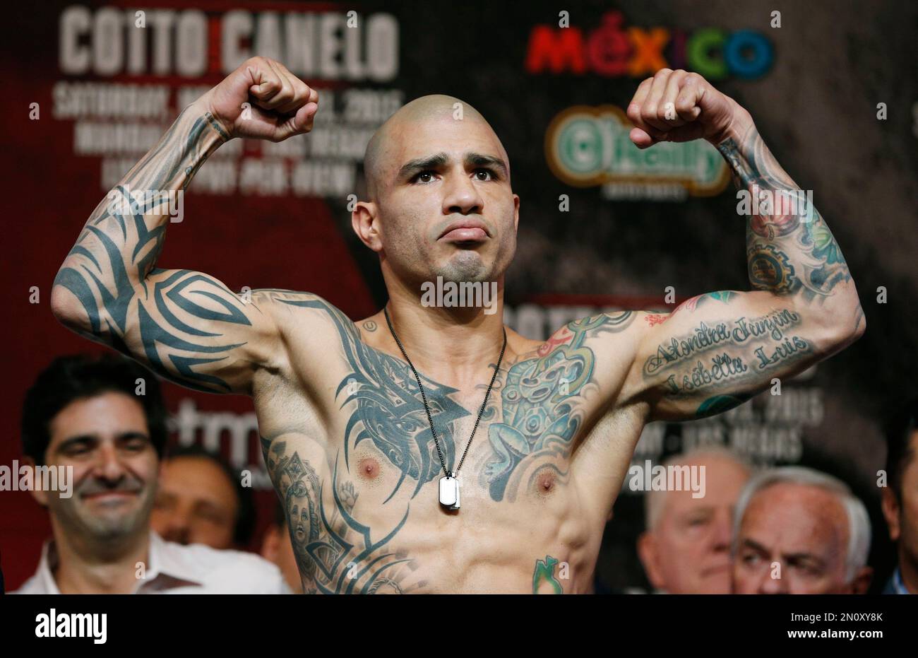 Miguel Cotto, of Puerto Rico, poses on the scale during a weigh-in ...