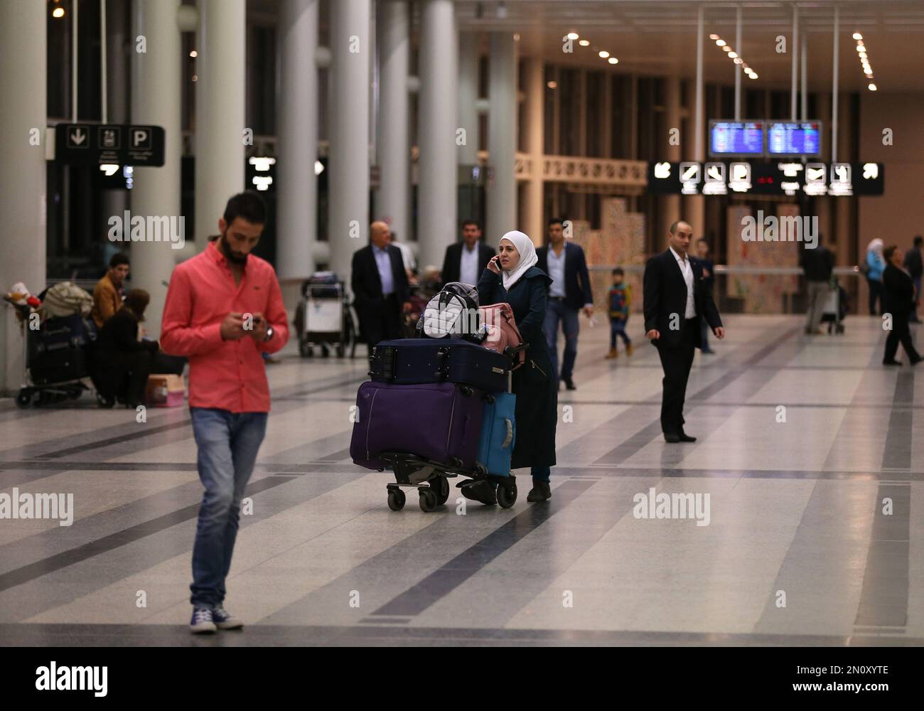 Travelers walk at the departure terminal of Rafik Hariri international ...