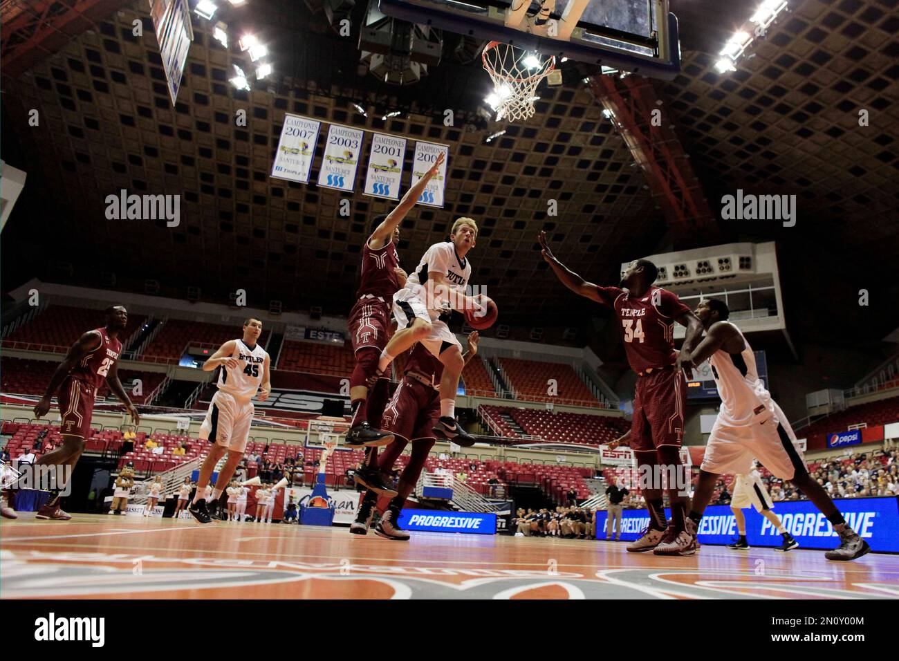 Butler guard Tyler Lewis, center, drives against Temple’s defense ...