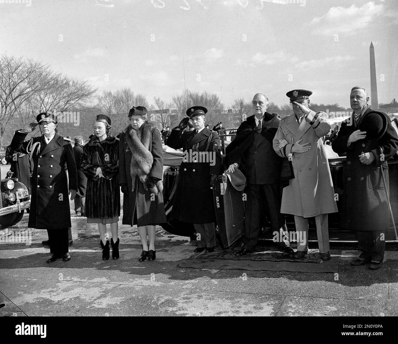 President Franklin D. Roosevelt stands bareheaded in front of the tomb ...
