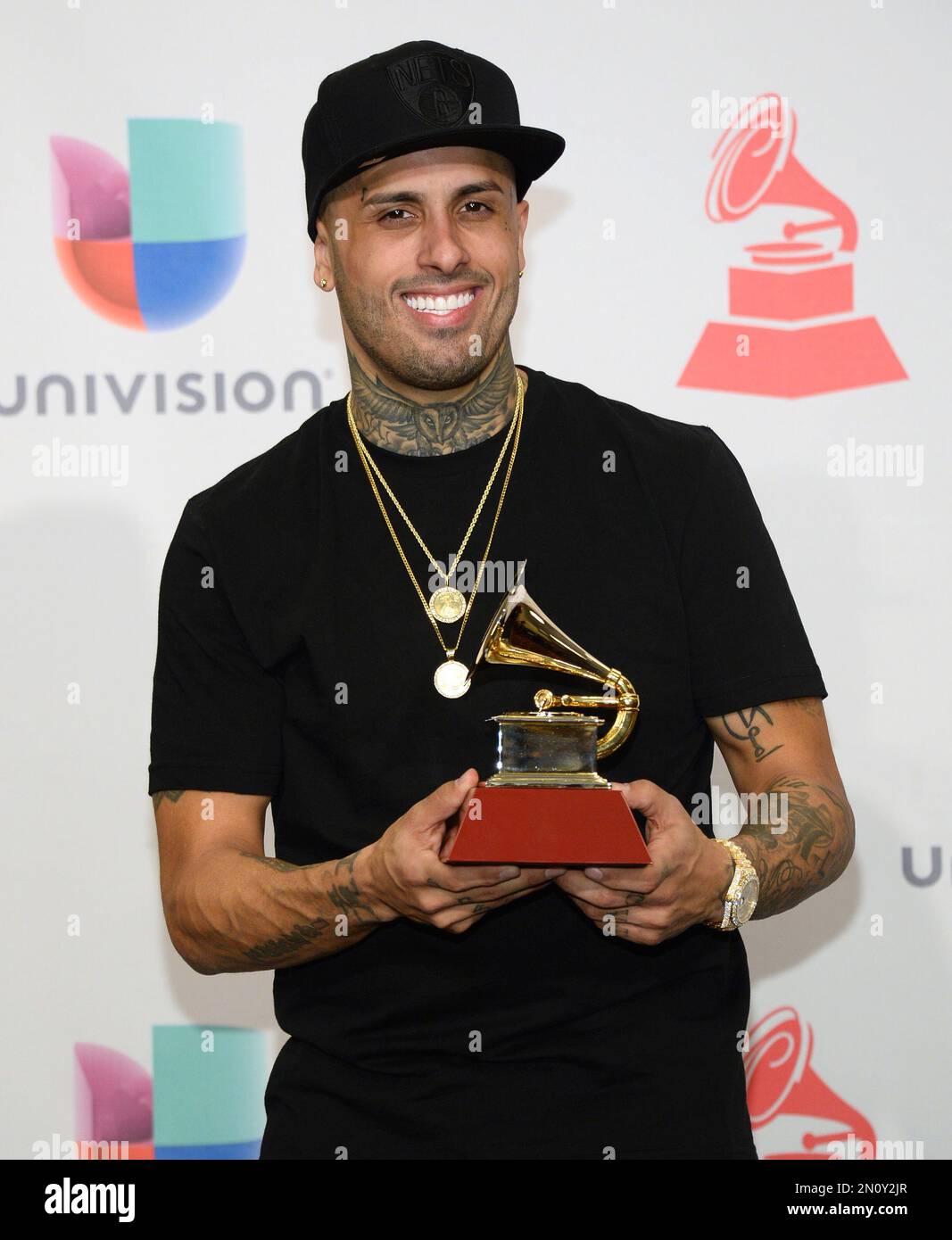 Nicky Jam poses in the pressroom with the award for best urban ...
