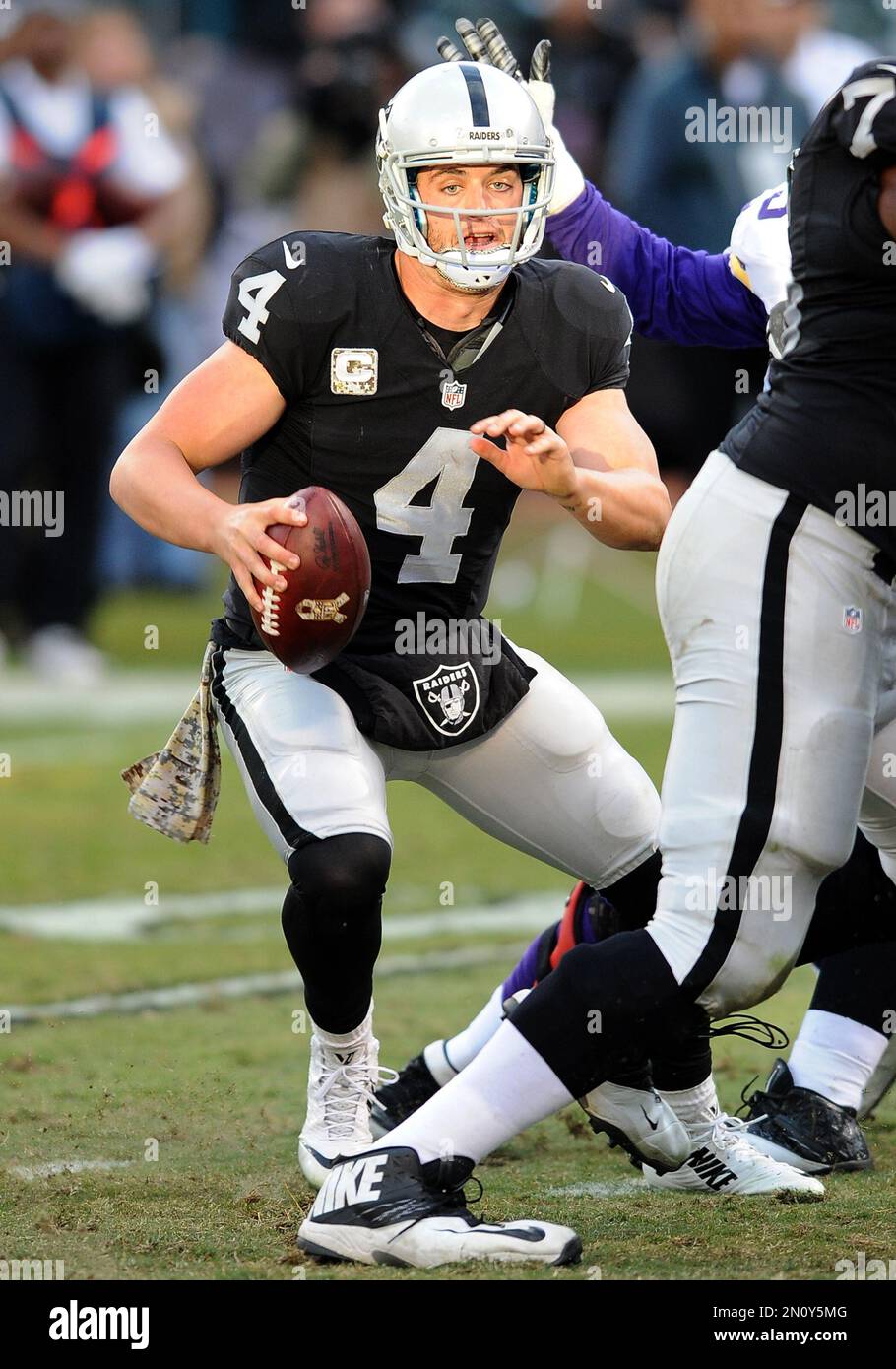 Oakland Raiders quarterback (4) Derek Carr on the run during a game ...