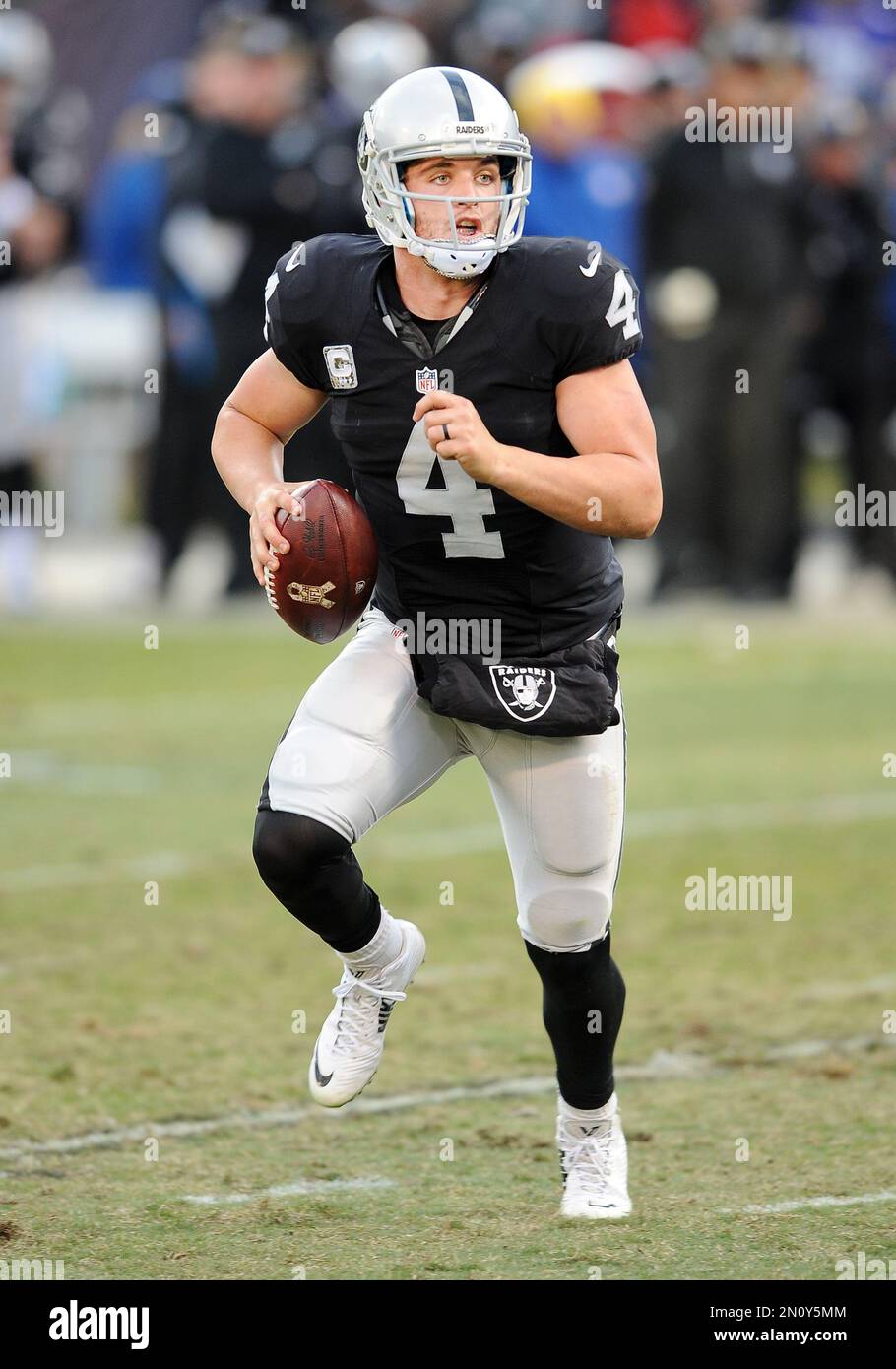 Oakland Raiders quarterback (4) Derek Carr on the run during a game ...