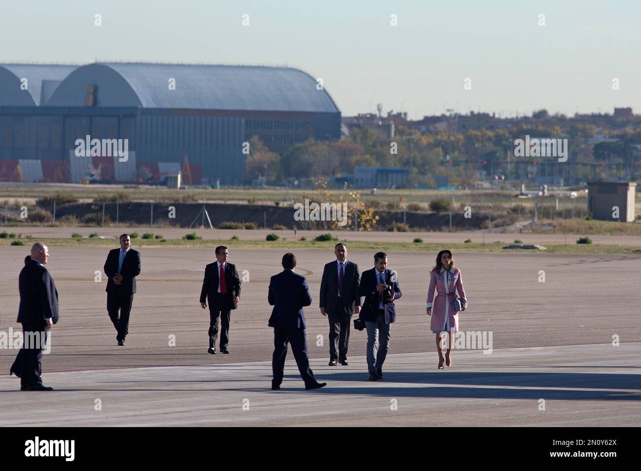 Jordan's Queen Rania, right,walks towards King Abdullah II's plane at ...