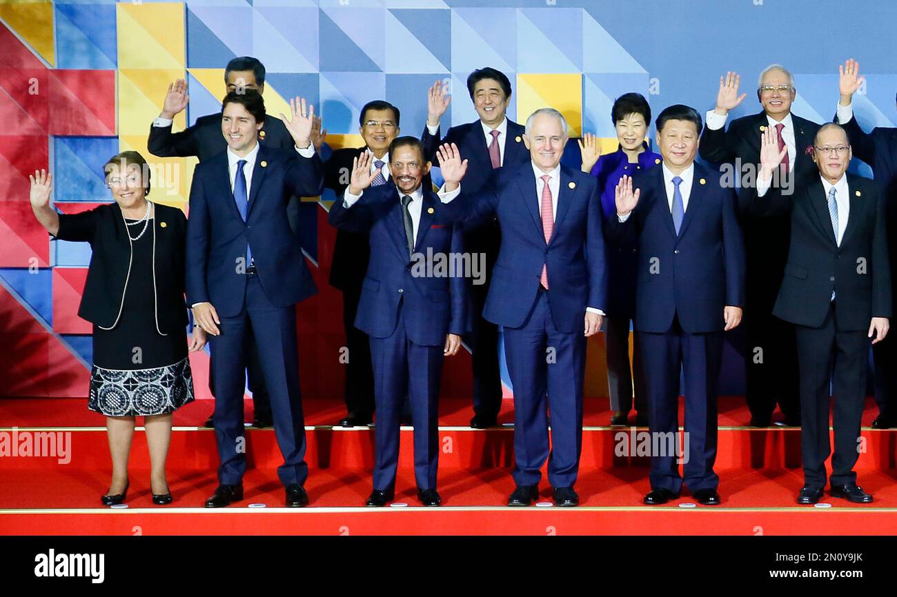Leaders wave as they pose for a group family photo at the Asia-Pacific ...