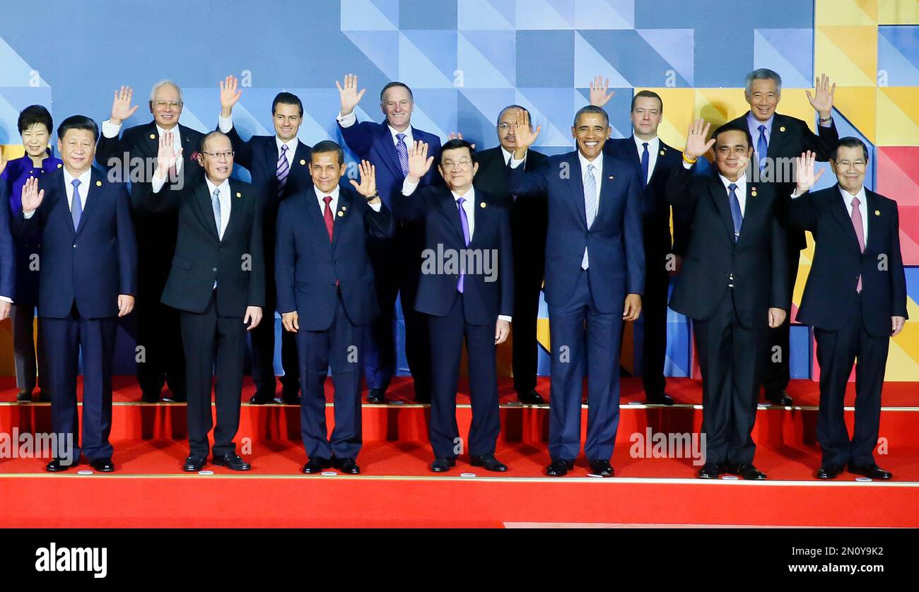 Leaders wave as they pose for a group family photo at the Asia-Pacific ...