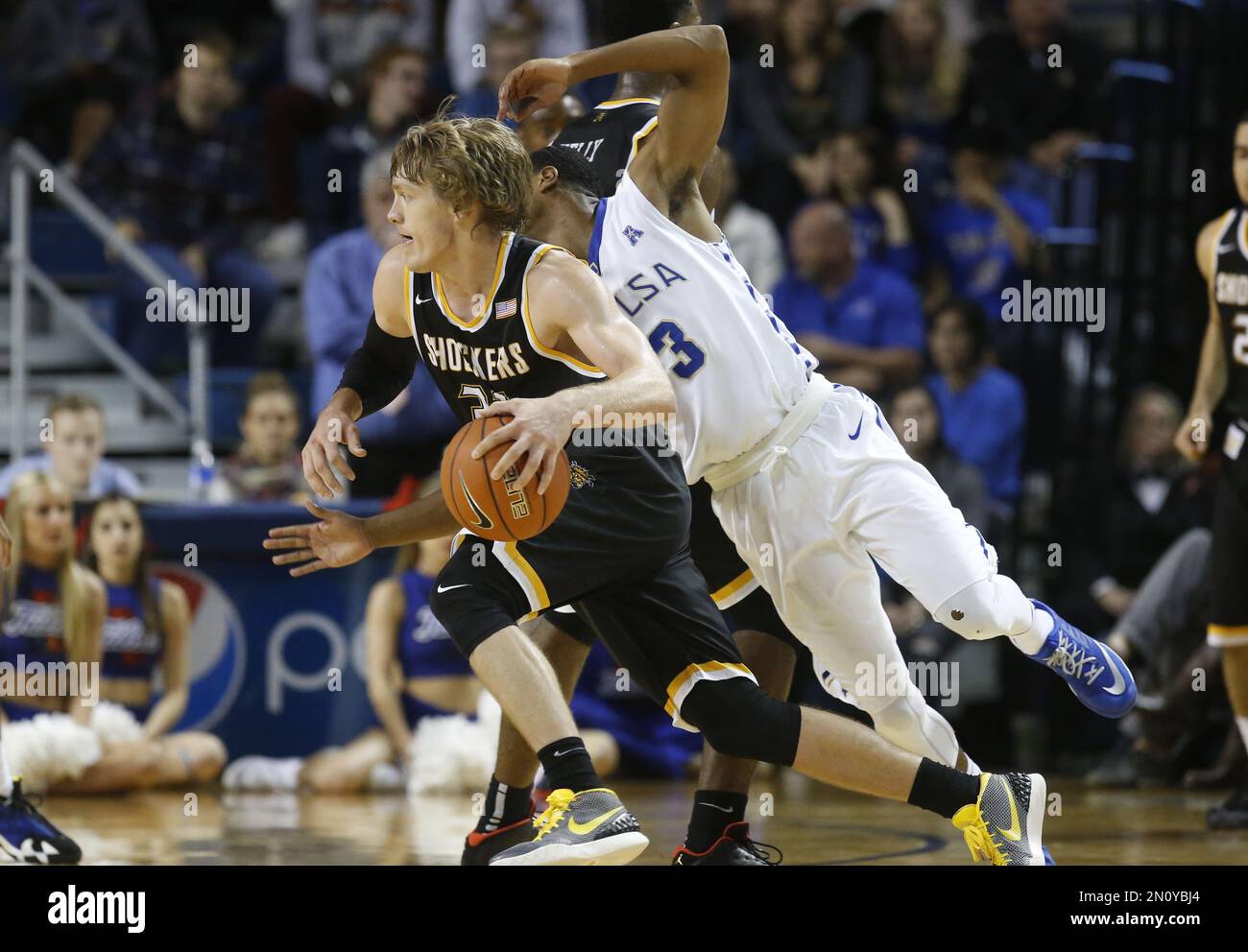 Wichita State guard Ron Baker (31) drives around Tulsa guard Shaquille ...