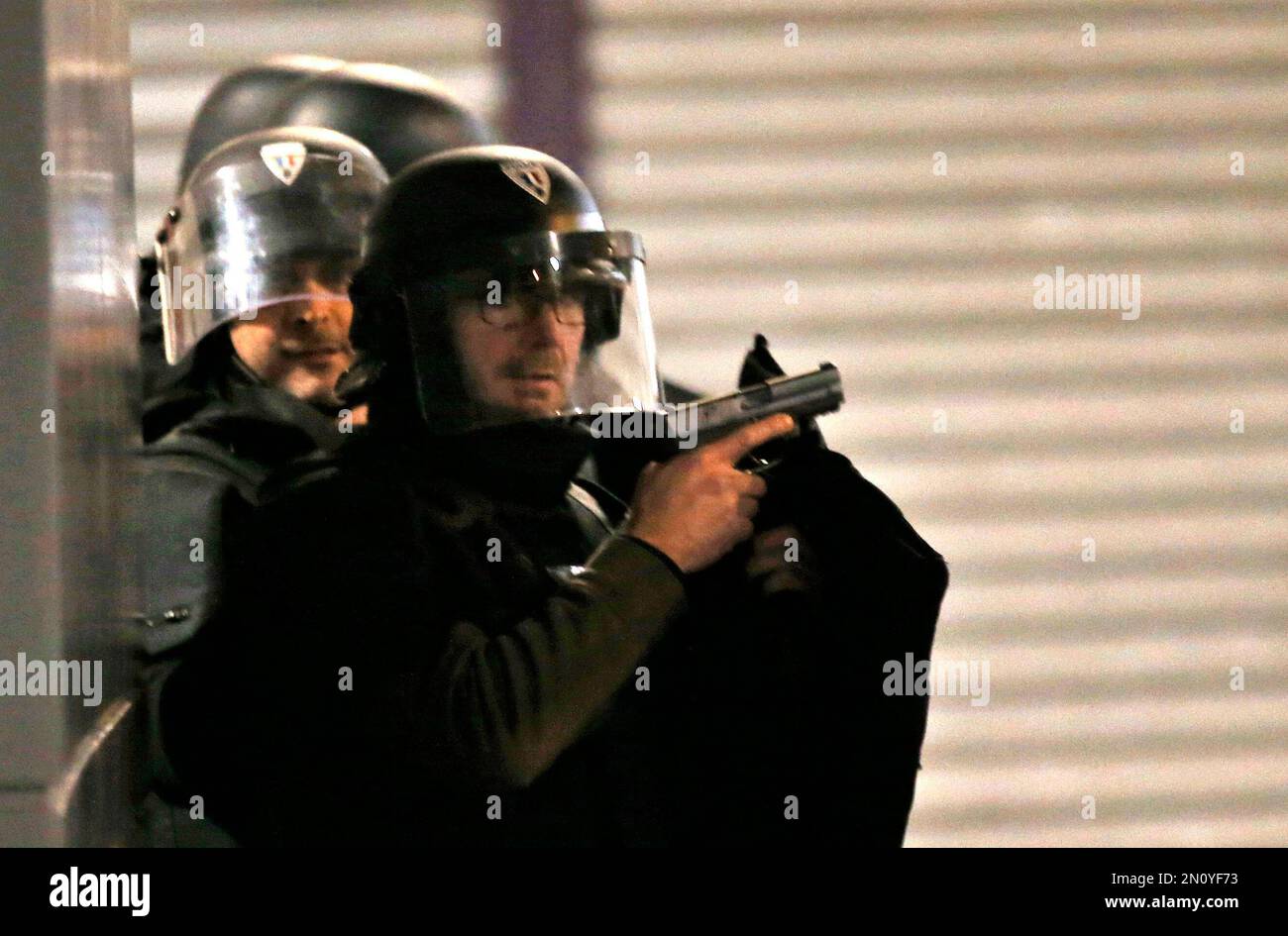 Armed police officers take up positions in Saint Denis, a northern ...