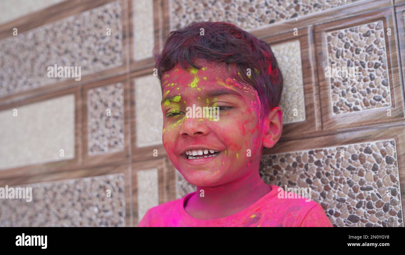 Attractive Boy in pink colors Holi. Holi facial shot on spring color ...