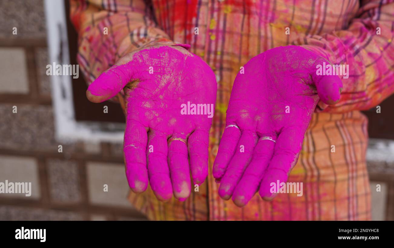 Hands or Palms of young people covered in purple, yellow, red, blue ...