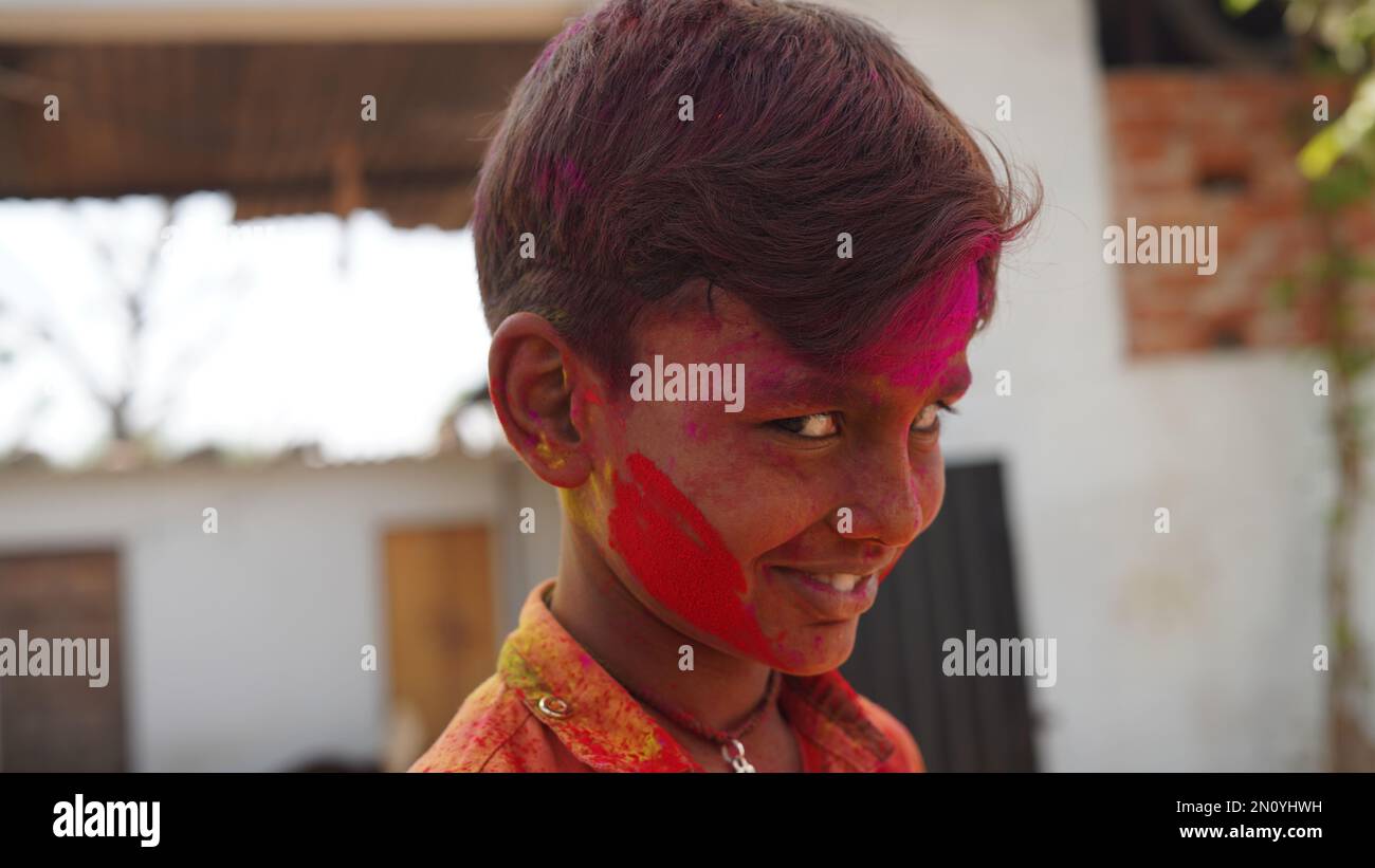 Holi celebrations Indian little boy playing Holi and showing face ...