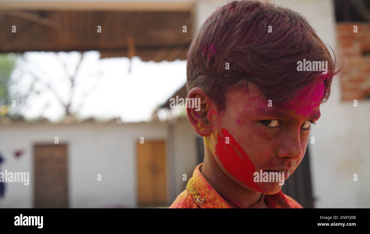 Cute indian little child playing holi. Holi is colors festival in india ...