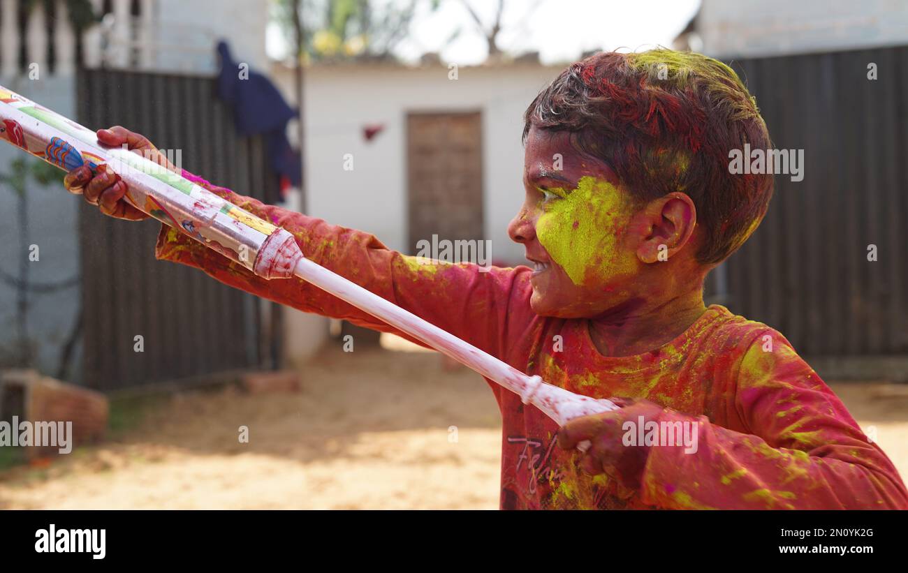 Cute indian little child playing holi. Holi is colors festival in india ...
