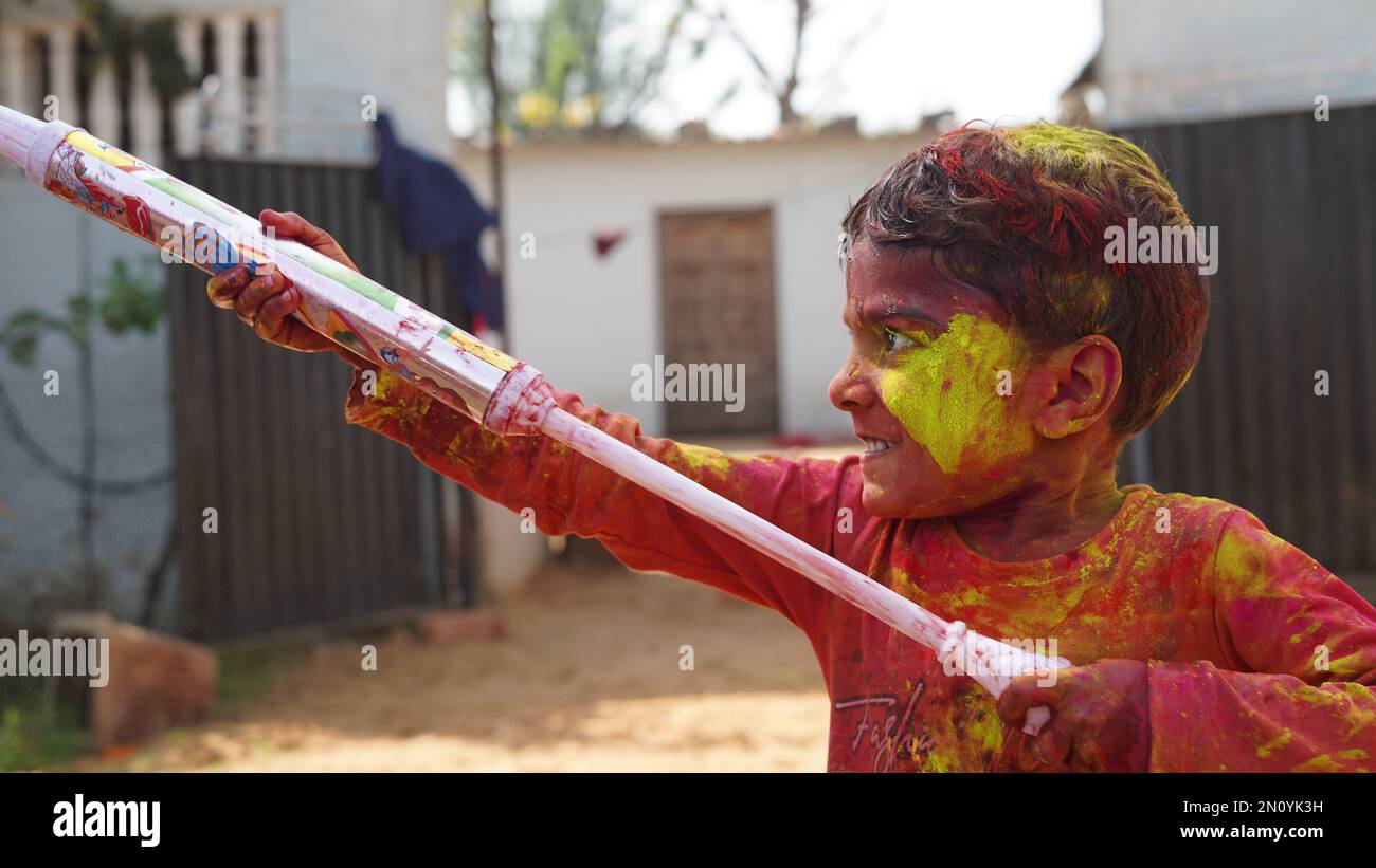 Holi celebrations Indian little boy playing Holi and showing face ...