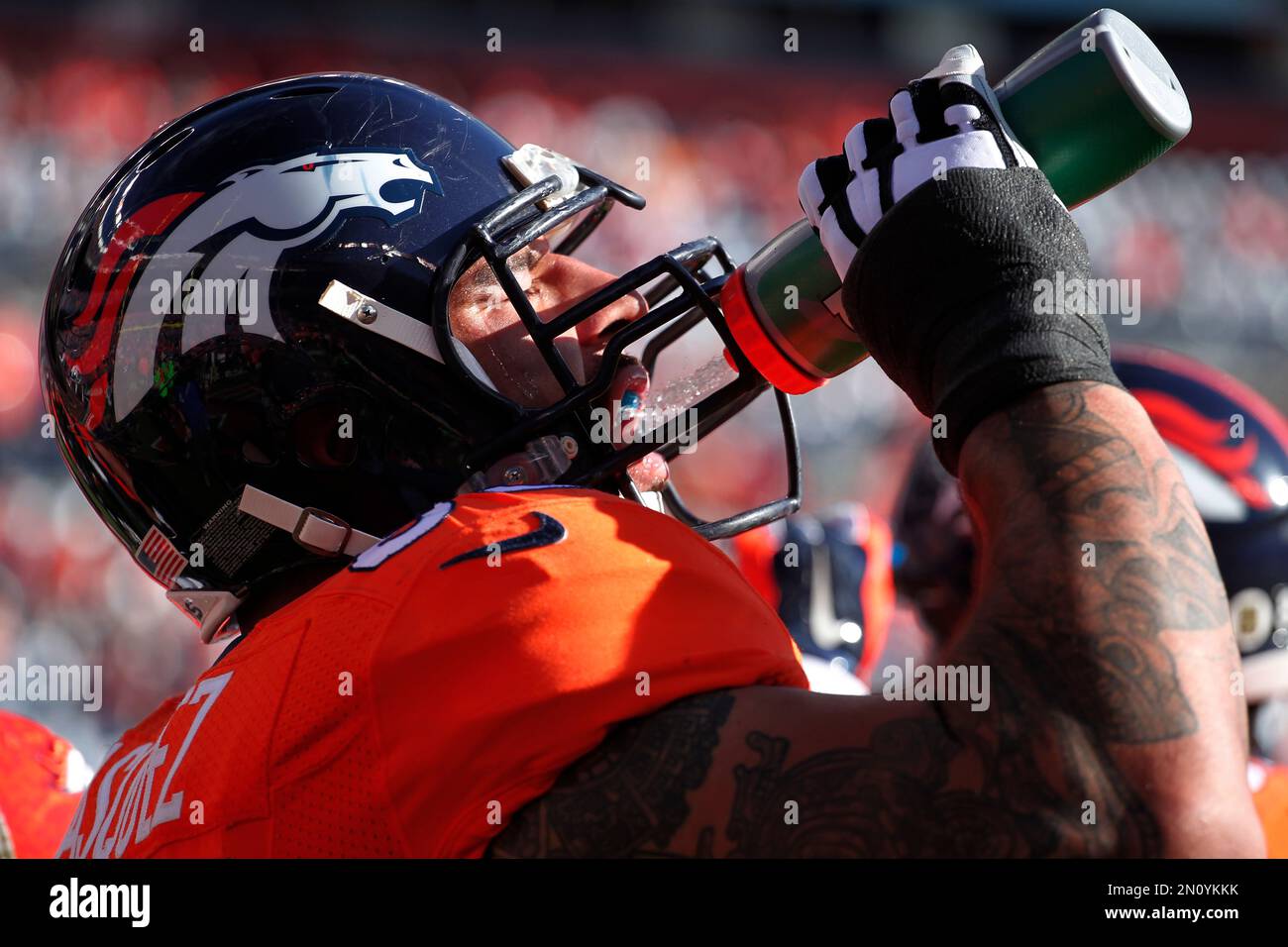 Denver Broncos offensive guard Louis Vasquez cools off with a drink of ...