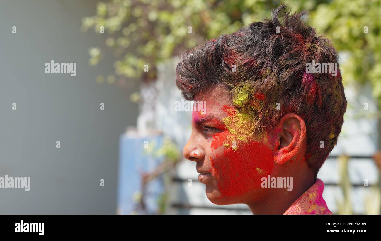 Cute indian little child playing holi. Holi is colors festival in india ...