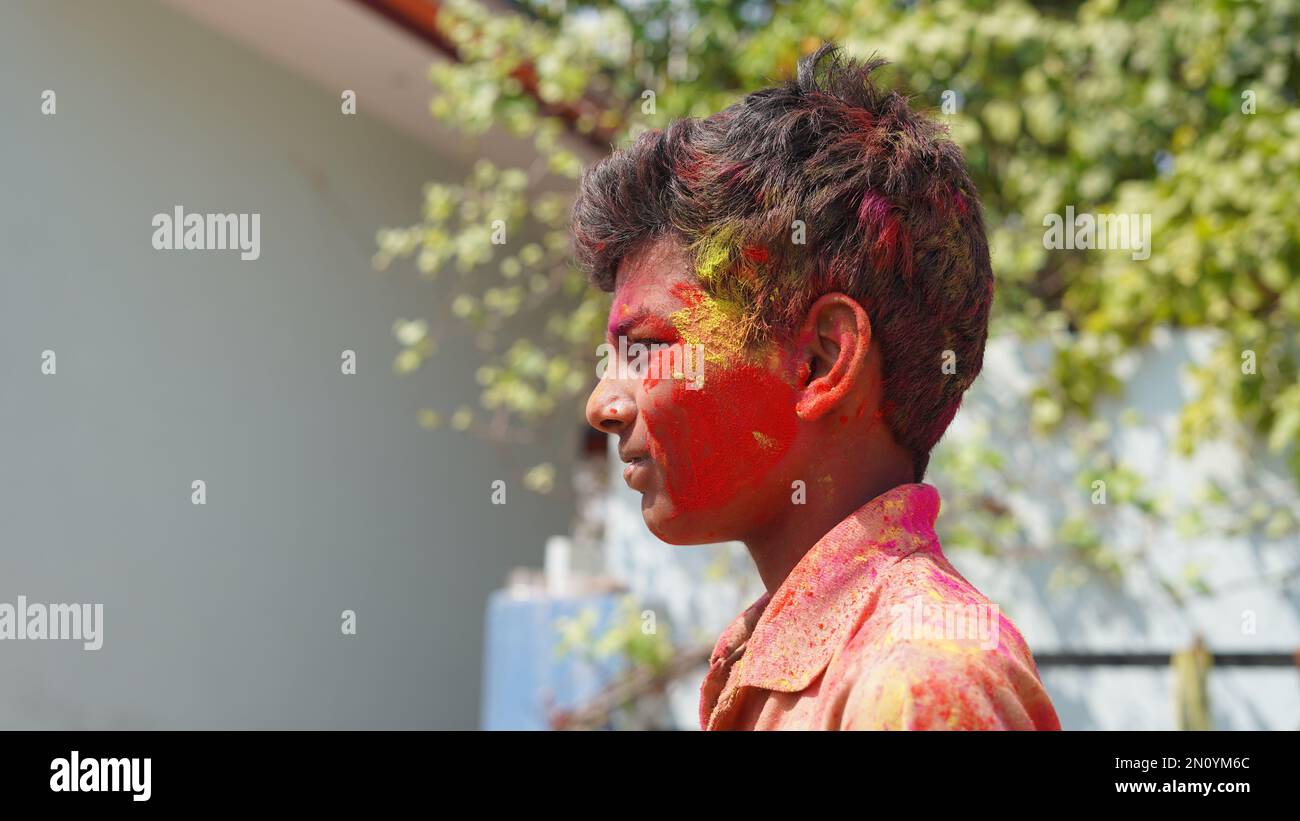 Holi celebrations Indian little boy playing Holi and showing face ...