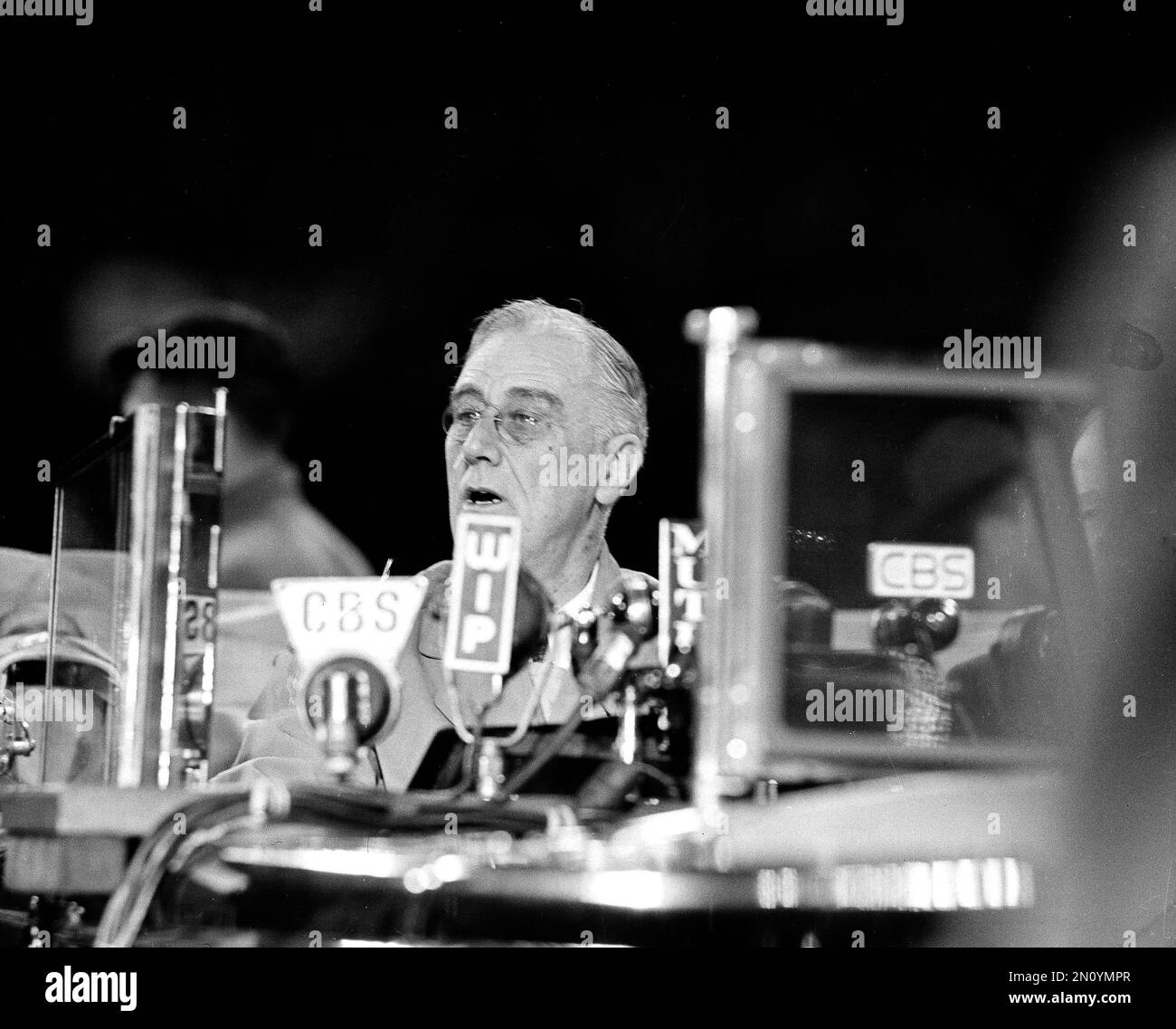President Franklin D. Roosevelt speaks from the rear seat of his car in ...