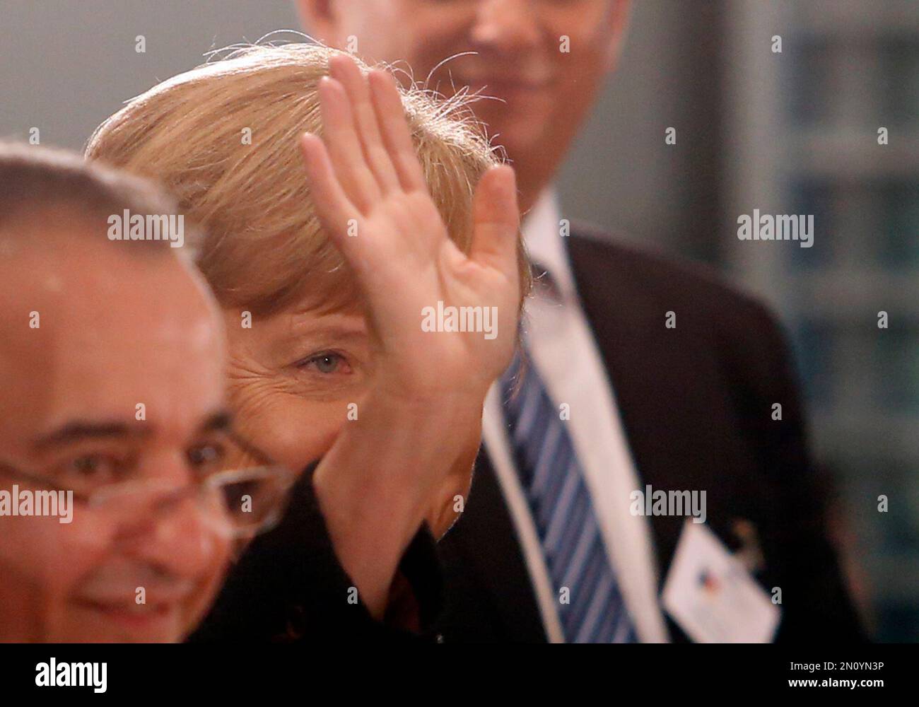German Chancellor Angela Merkel waves as she arrives for the so-called ...