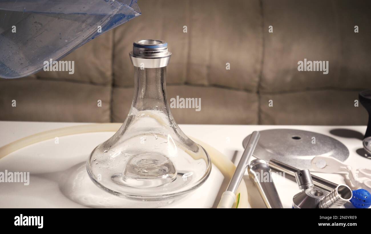 Cooking hookah. Step by step. A hookah man collects a hookah piece by ...