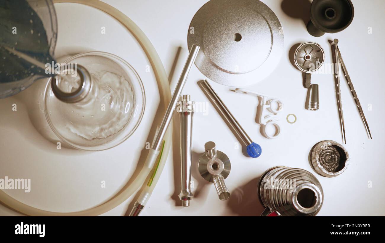 Cooking hookah. Step by step. A hookah man collects a hookah piece by ...
