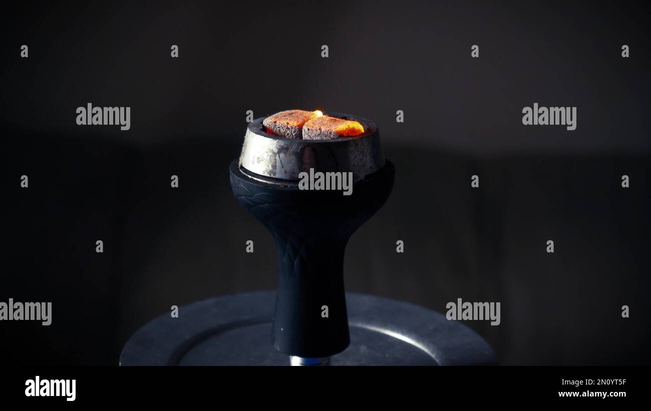 Close-up of burning embers on hookah. Square red coals ignite when ...