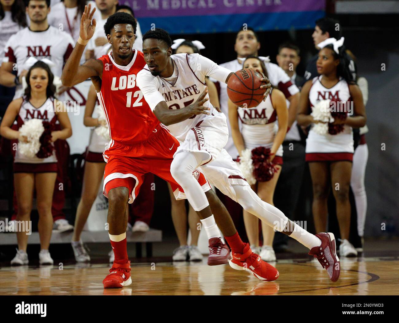 New Mexico State guard Jalyn Pennie, right, drives with the ball as he ...