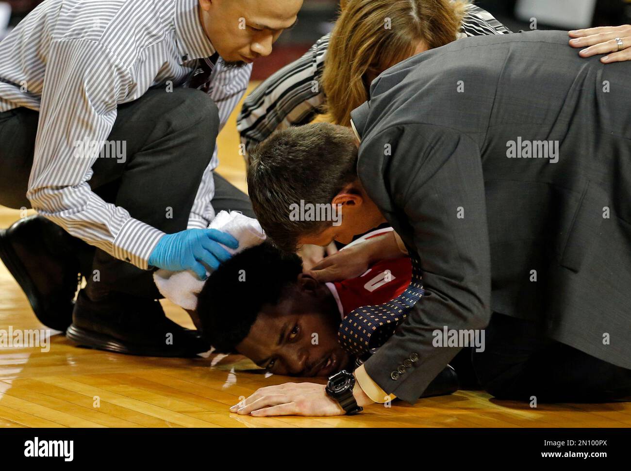New Mexico forward Devon Williams is checked by doctors after hurting ...