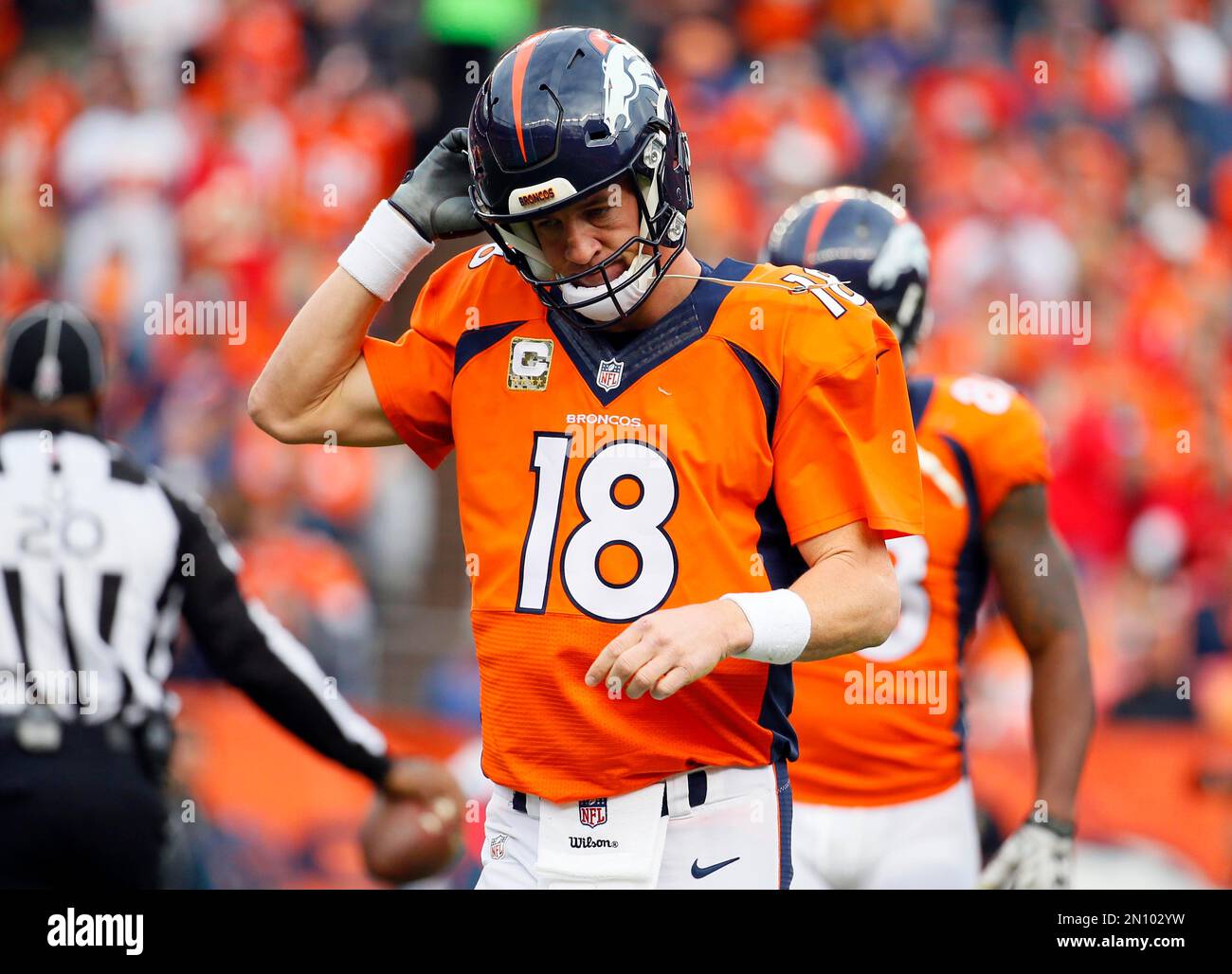 Denver Broncos quarterback Peyton Manning (18) takes off his helmet ...