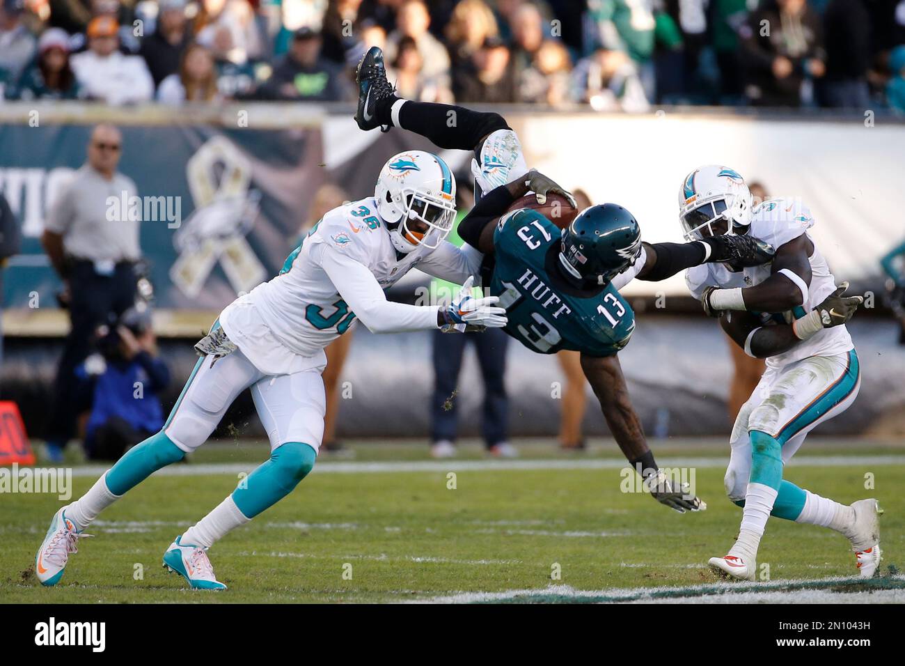 Philadelphia Eagles' Josh Huff (13) is tackled by Miami Dolphins' Tony ...