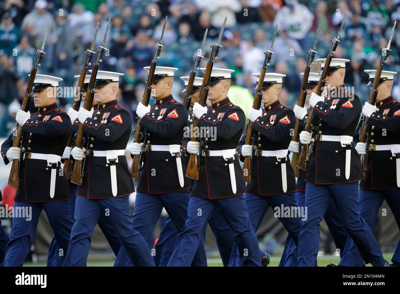 Marines march onto the field during halftime of an NFL football game ...