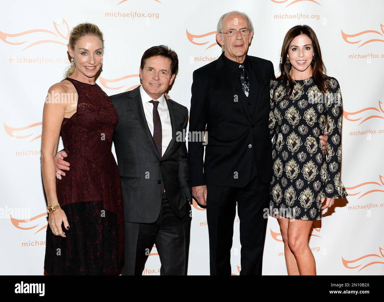 Actor Michael J. Fox and wife Tracy Pollan, left, pose with actor ...