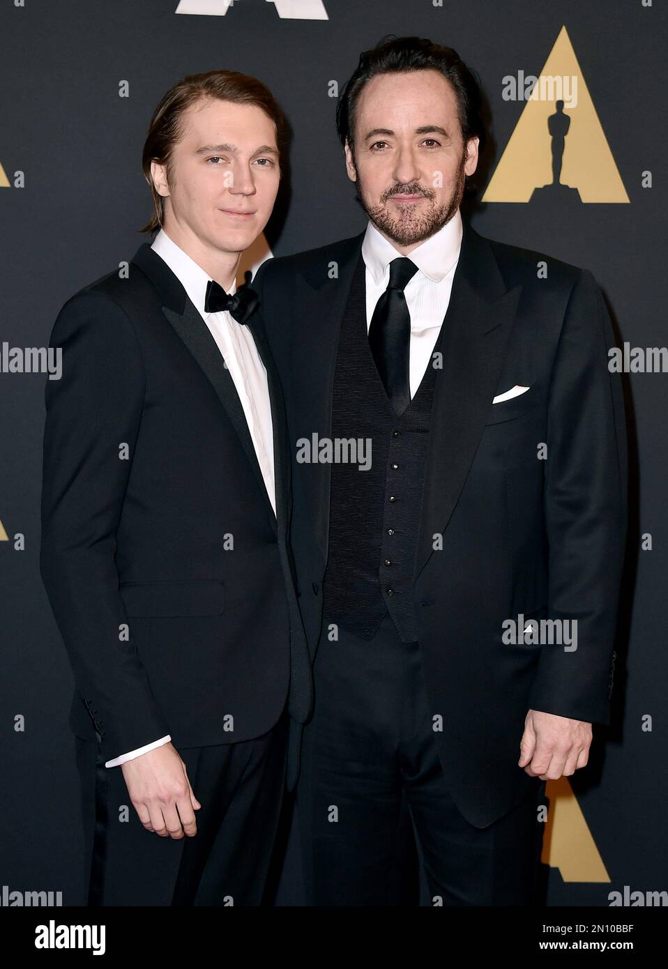 Paul Dano, left, and John Cusack arrive at the Governors Awards at the ...