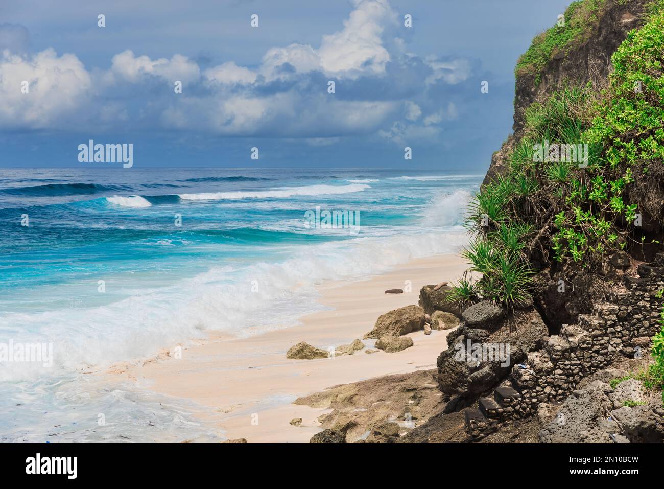 Tropical beach with blue ocean waves in Bali island Stock Photo - Alamy