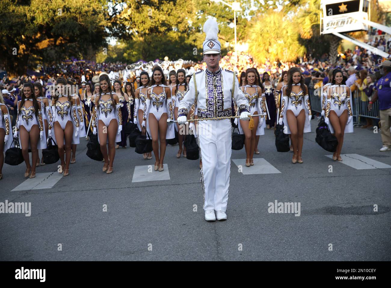 The LSU marching band drum major leads the LSU Golden Girls cheerleader ...