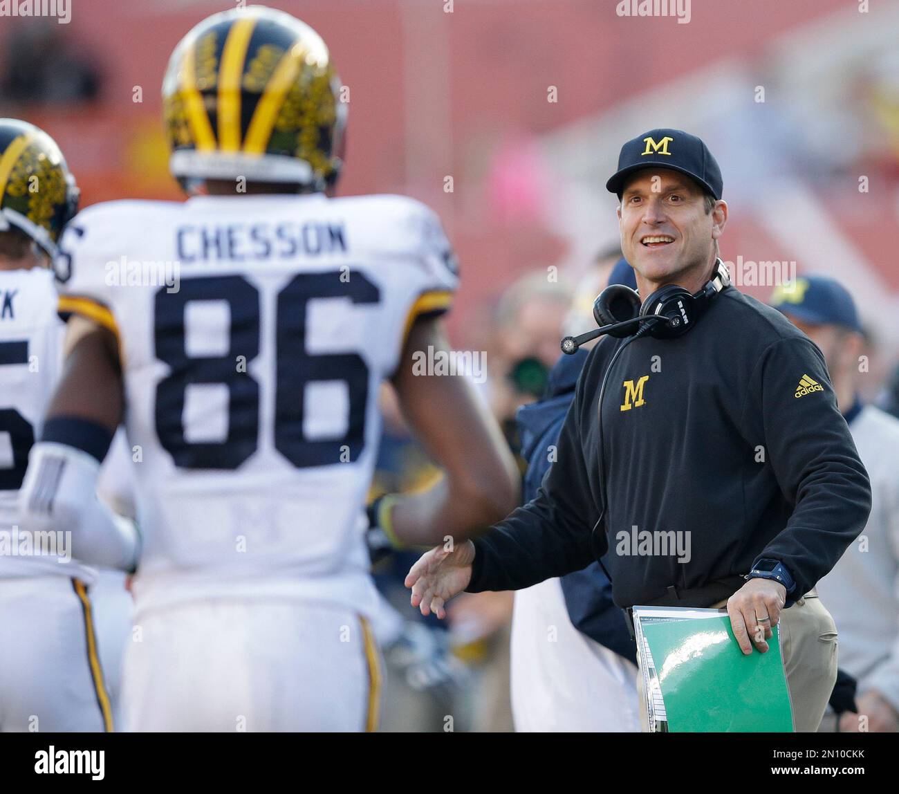 Michigan head coach Jim Harbaugh congratulates Jehu Chesson (86) after ...