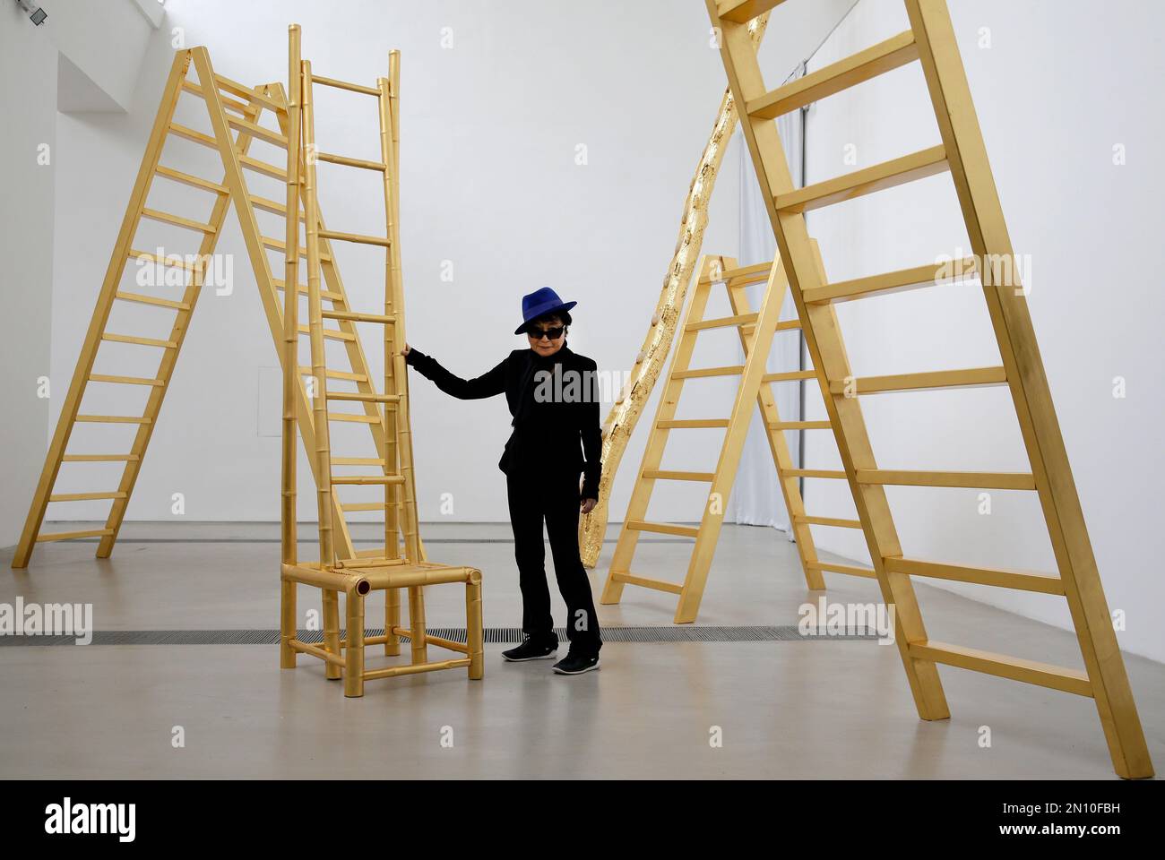 Artist Yoko Ono poses with her art installation "Golden Ladders" on ...