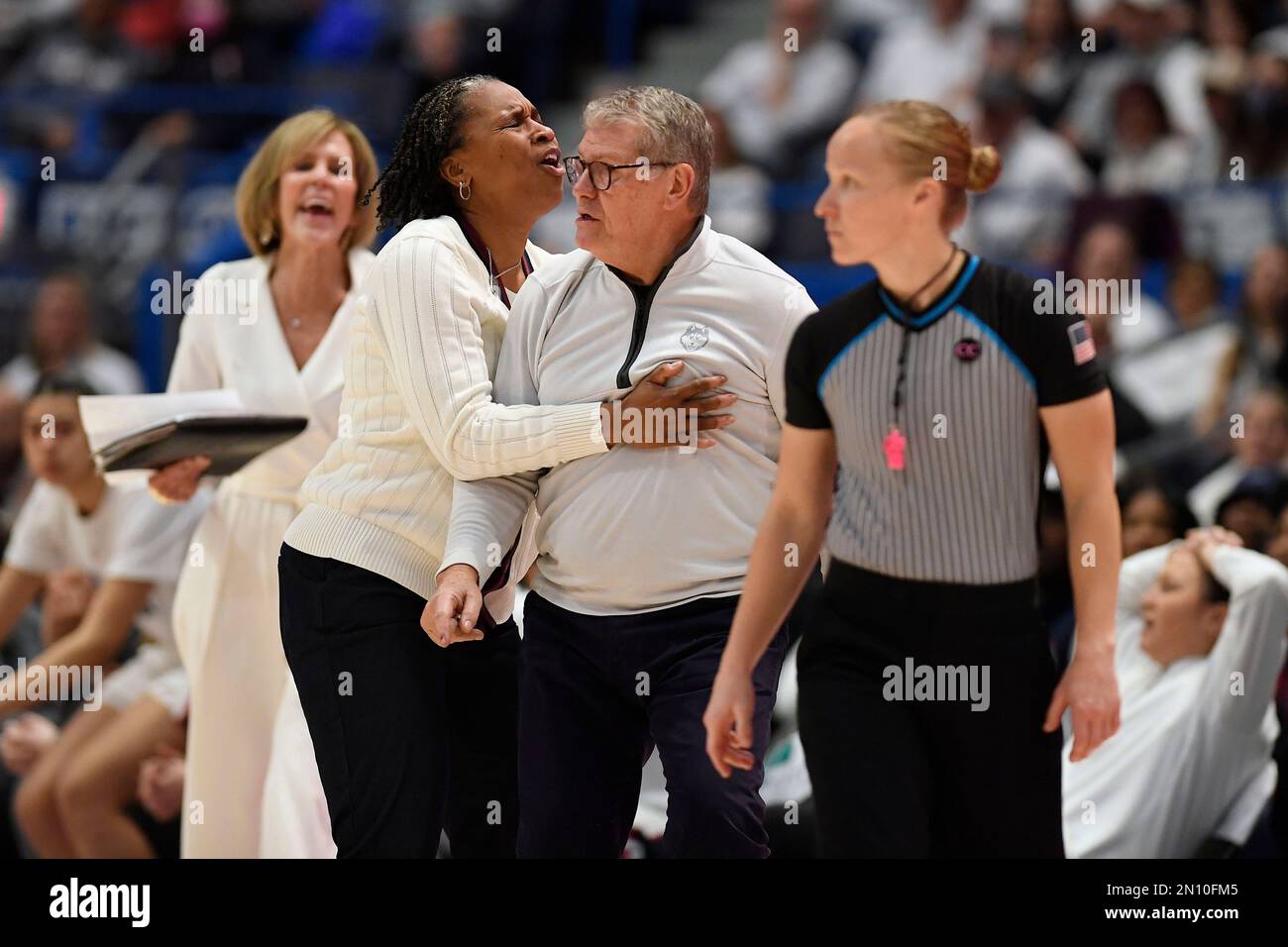 UConn head coach Geno Auriemma is held back by assistant coach Jamelle ...