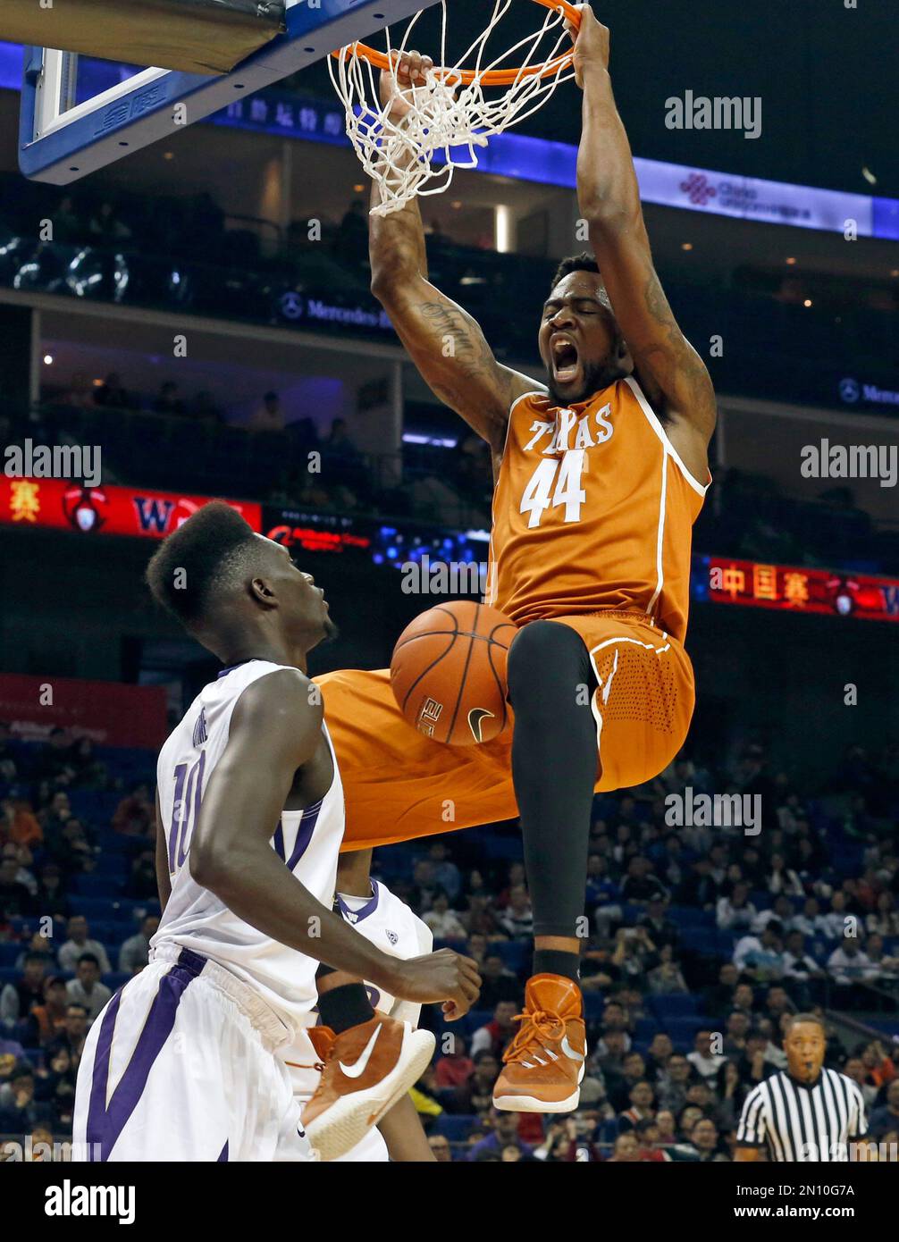 Prince Ibeh of the Texas Longhorns slams dunk the ball near Malik Dime ...