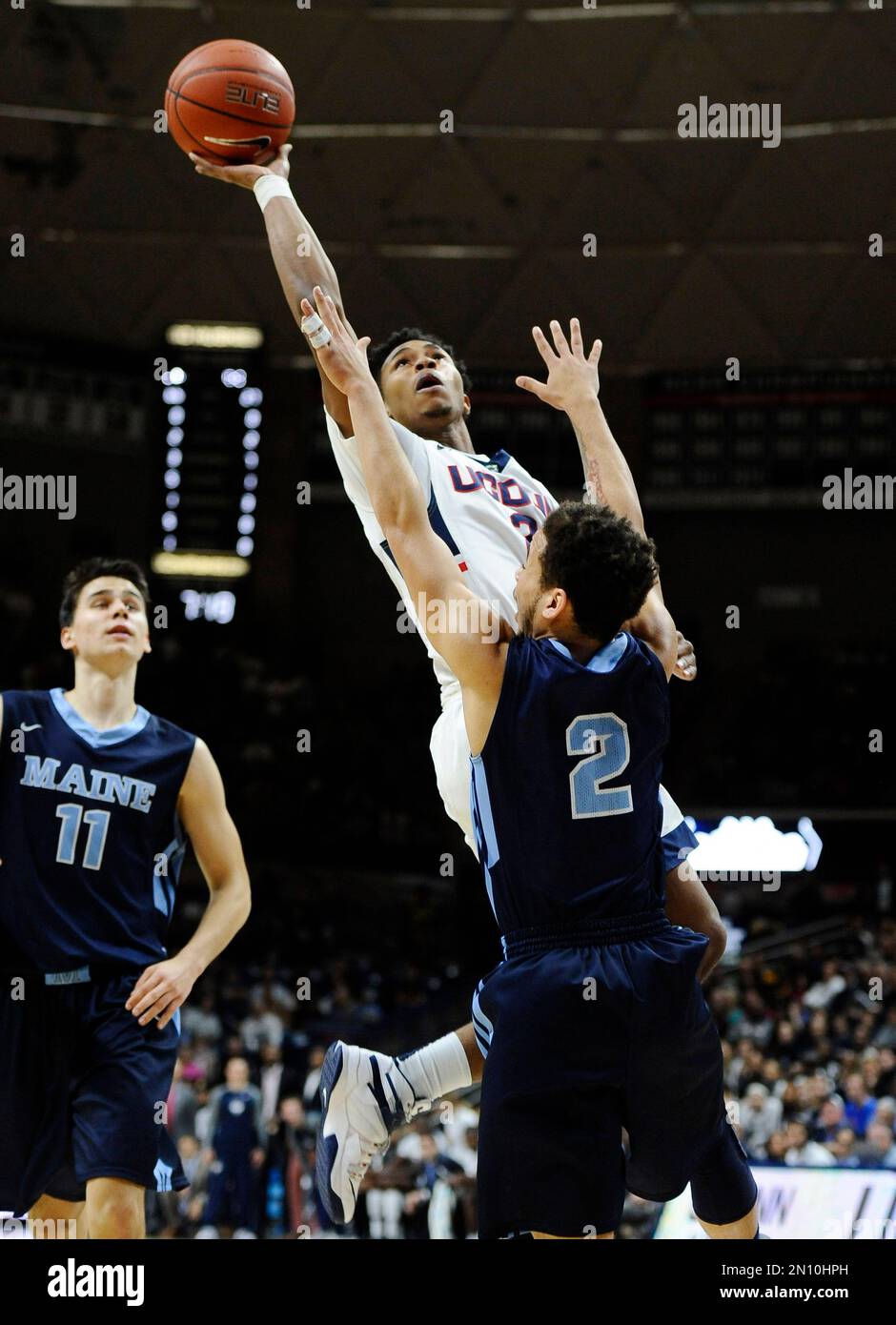 Connecticut's Jalen Adams shoots over Maine's Kevin Little during the ...