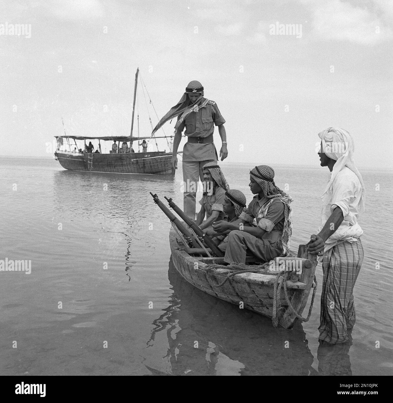 Armed Arab soldiers of the Trucial Oman Scouts ride out to board the ...