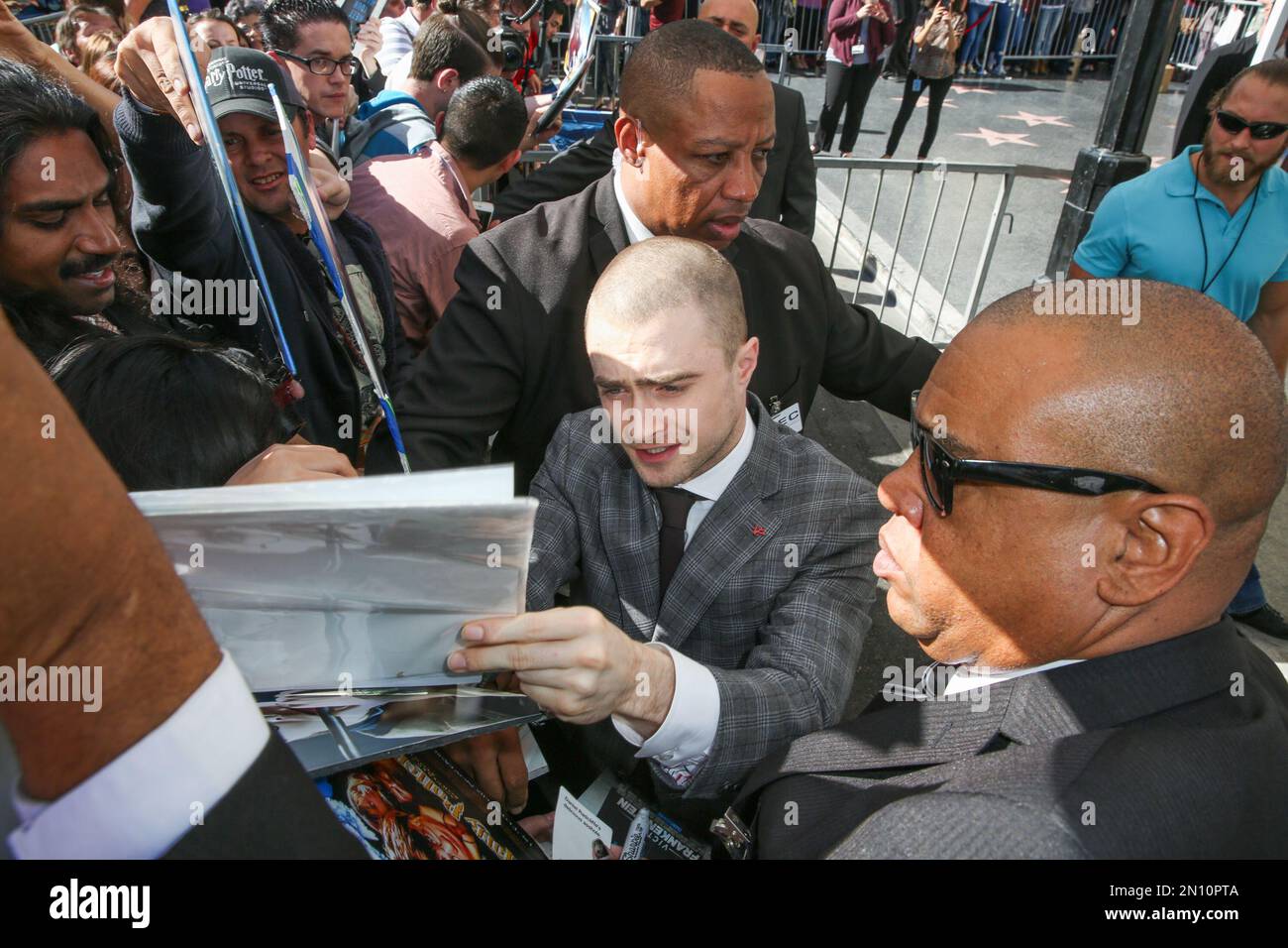Daniel Radcliffe signs autographs for fans at a ceremony honoring him ...