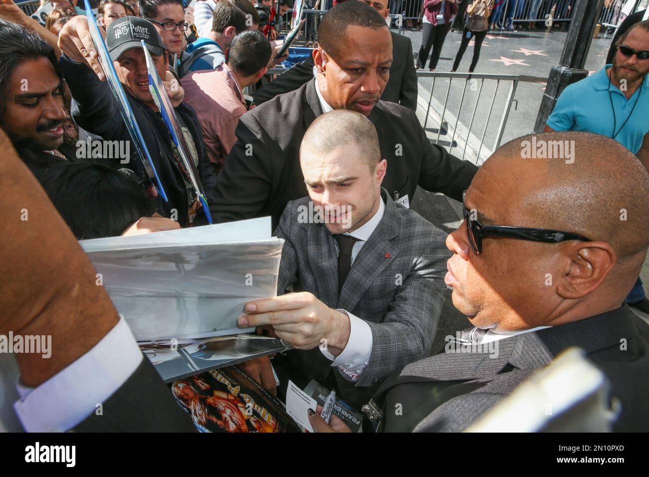 Daniel Radcliffe signs autographs for fans at a ceremony honoring him ...