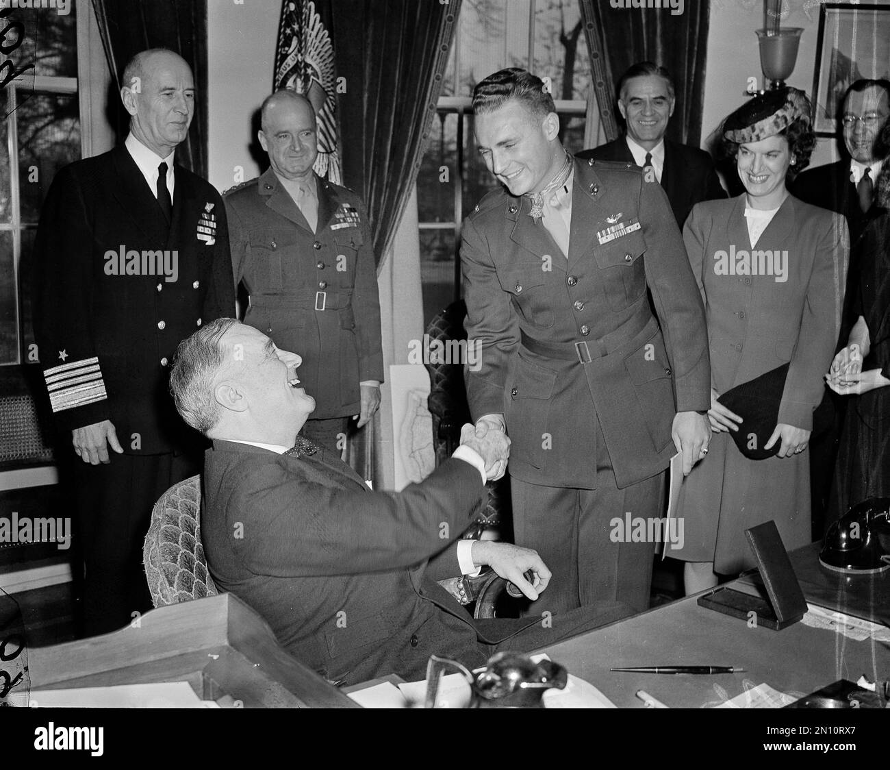 President Franklin D. Roosevelt shakes hands with Lt. Kenneth A. Walsh ...