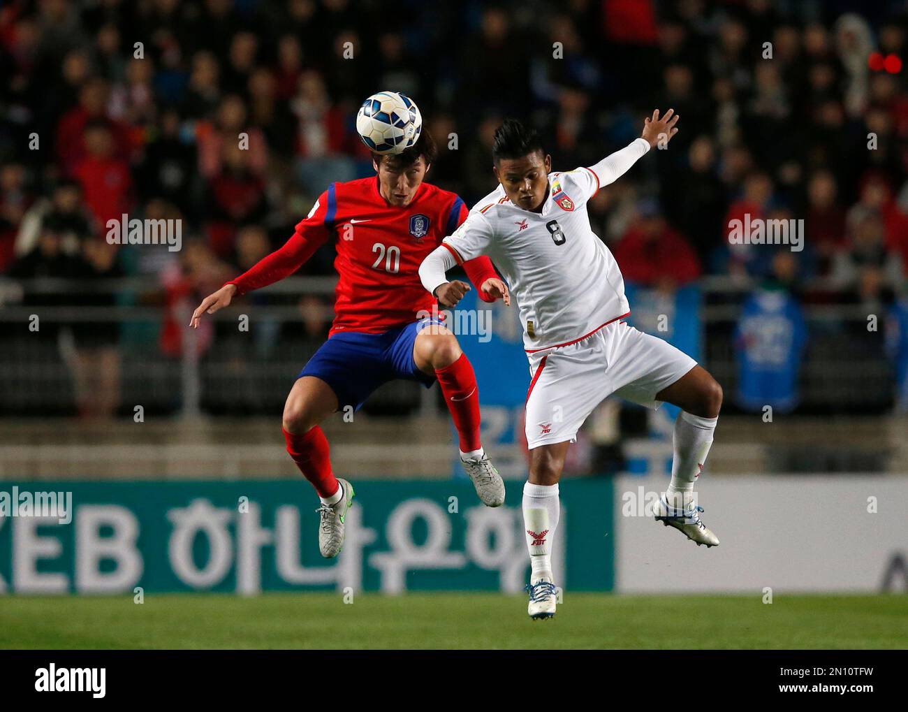 South Korea's Jang Hyun-soo, left, fights for the ball with Myanmar's ...