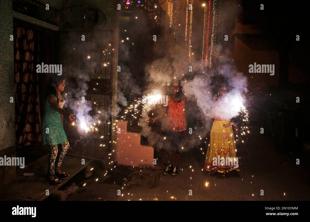 Indians play with firecrackers during Diwali celebrations in New Delhi ...
